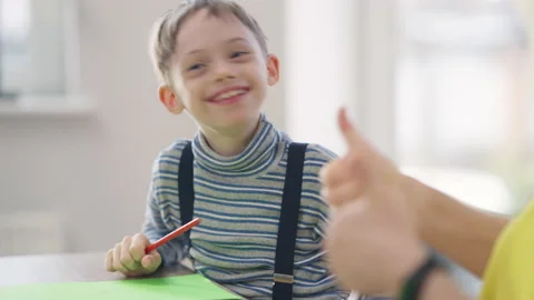 Portrait of excited autistic boy smiling... | Stock Video | Pond5