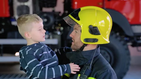 Portrait of firefighter with cute boy on... | Stock Video | Pond5