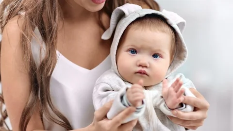 Portrait of focused cute baby wearing wh... | Stock Video | Pond5