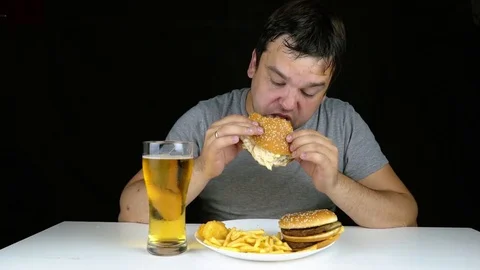 Portrait of a greedy fat man eating burg... | Stock Video | Pond5