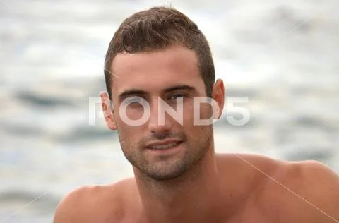 Portrait of handsome male model Shirtless male model grinning and ...