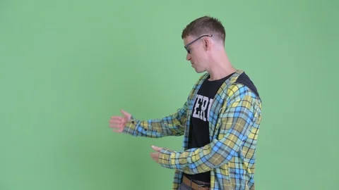 Portrait of happy nerd man showing to ba... | Stock Video | Pond5