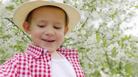 Portrait of little boy in the spring gar... | Stock Video | Pond5