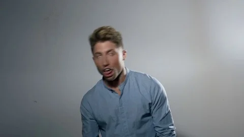 Portrait of a Male Model: Throwing Up Fa... | Stock Video | Pond5