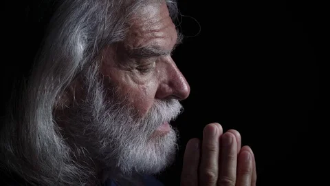 Portrait of old man praying god in the d... | Stock Video | Pond5