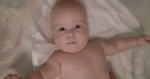 Portrait of perplexed baby boy looking a... | Stock Video | Pond5