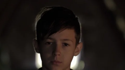 portrait of a serious sad boy in a dark ... | Stock Video | Pond5