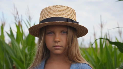 Portrait of small serious girl in straw ... | Stock Video | Pond5