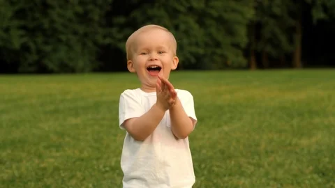 Portrait of smiling baby boy clapping ha... | Stock Video | Pond5