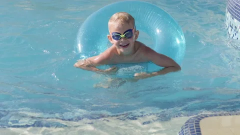 Portrait smiling boy in swimming pool, c... | Stock Video | Pond5