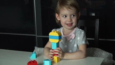 Portrait of smiling child girl builds to... | Stock Video | Pond5