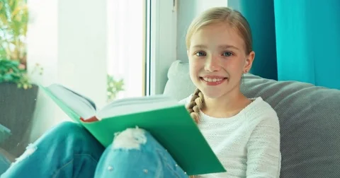 Portrait student child reading book smil... | Stock Video | Pond5