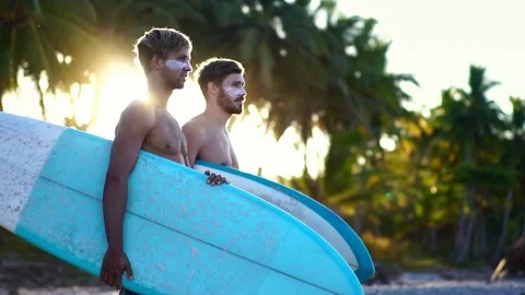 Portrait of two handsome surfer guy frie... | Stock Video | Pond5