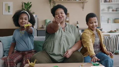 Portrait of Two Kids and Grandma Demonst... | Stock Video | Pond5