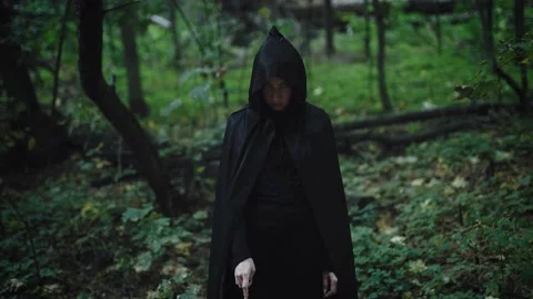 Portrait of a witch in a black cloak wit... | Stock Video | Pond5
