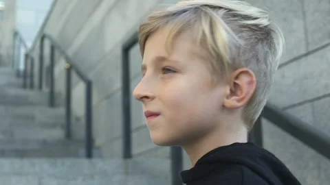 Portrait of young boy looking back, happ... | Stock Video | Pond5