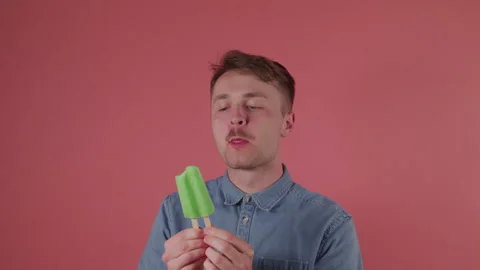 Portrait of a Young Man Eating a Popsicl... | Stock Video | Pond5