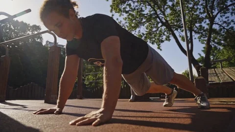 Portrait of a young man holing plank on ... | Stock Video | Pond5