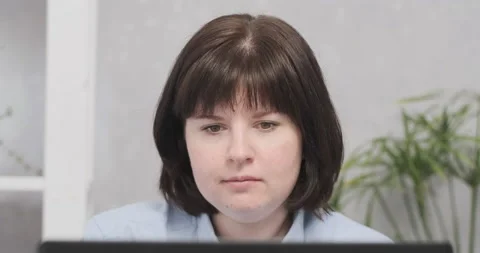 Portrait young woman looks at monitor sc... | Stock Video | Pond5