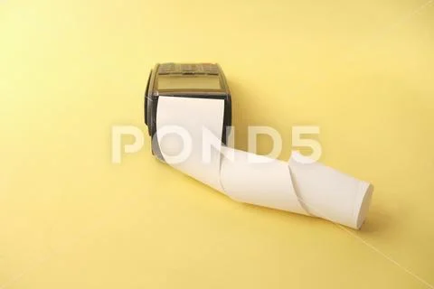 POS machine and long roll paper on yellow background ~ Hi Res #168693943