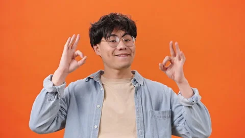 Positive Asian man shows thumbs up and O... | Stock Video | Pond5
