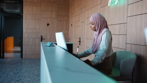 Positive Muslim woman receptionist looki... | Stock Video | Pond5