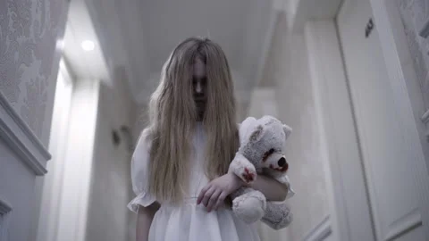 Possessed little girl holding bloody toy... | Stock Video | Pond5