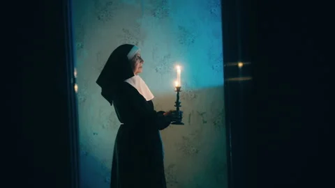 Possessed nun ghost holding burning cand... | Stock Video | Pond5