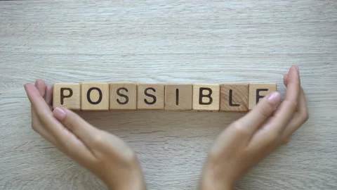 Possible, hands pushing word on wooden c... | Stock Video | Pond5