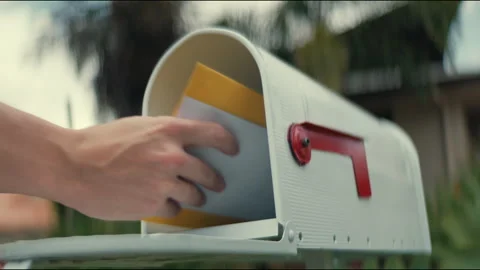 Postman inserting mail into the mailbox | Stock Video | Pond5
