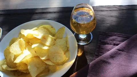 potato chips and drink on a dark backgro... | Stock Video | Pond5