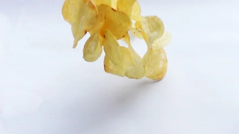 Potato chips fall down on the white pape... | Stock Video | Pond5