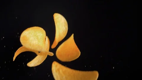 potato chips in free fall on a black bac... | Stock Video | Pond5