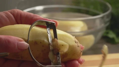 Potato peeler knife taking of skin from ... | Stock Video | Pond5
