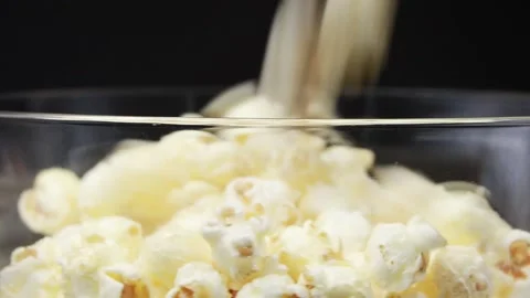 Pour Popcorn into a rotating glass on a ... | Stock Video | Pond5