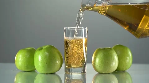 Pouring apple juice into the glass | Stock Video | Pond5