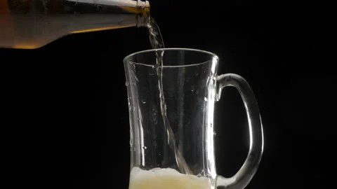 Pouring blonde beer on pint glass from b... | Stock Video | Pond5