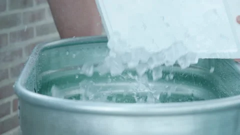 Pouring Box Of Ice Cubes Into Ice Bath T... | Stock Video | Pond5