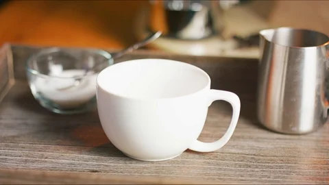 Pouring coffee in a white cup in real ti... | Stock Video | Pond5