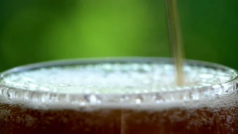 Pouring cold cola water into a transpare... | Stock Video | Pond5