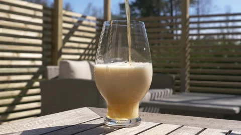 Pouring dark IPA beer in a glass on a wo... | Stock Video | Pond5