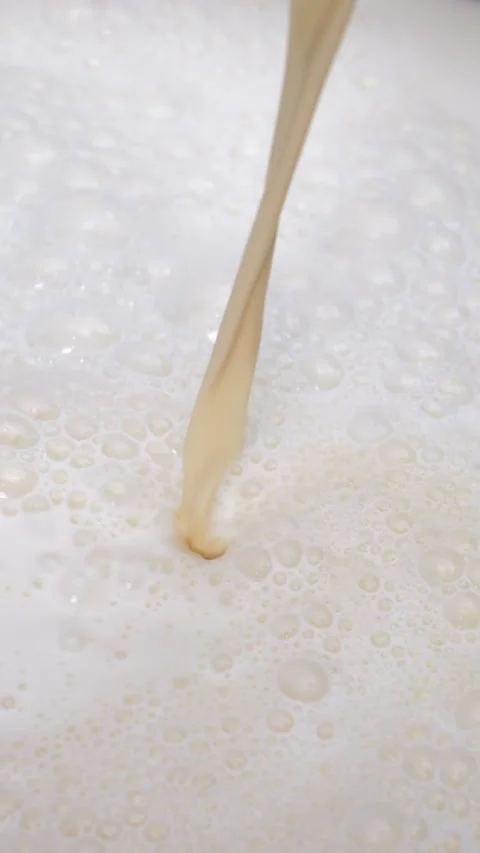 Pouring fresh milk into the mix, healthy... | Stock Video | Pond5