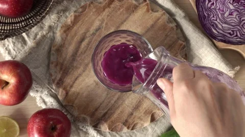 Pouring fresh purple cabbage juice from ... | Stock Video | Pond5