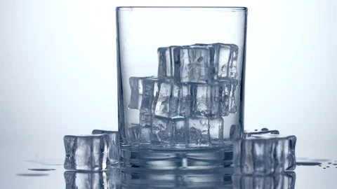 Pouring fresh water on ice cubes | Stock Video | Pond5