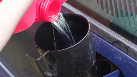Pouring fuel with funnel in a car gas ta... | Stock Video | Pond5