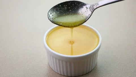 Pouring ghee in a bowl | Stock Video | Pond5