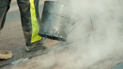 Pouring hot tar around the edges of newl... | Stock Video | Pond5