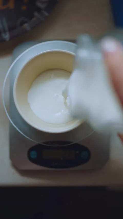 Pouring milk on a scale, making a cake, ... | Stock Video | Pond5