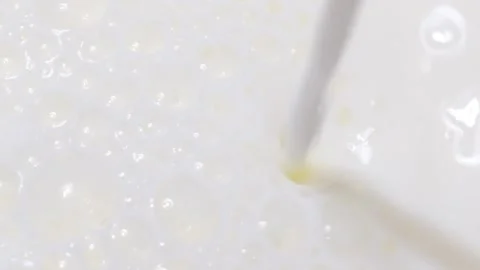 Pouring milk splash isolated on a white ... | Stock Video | Pond5