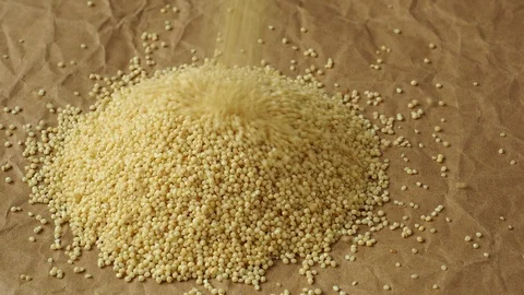 Pouring millet on crumpled paper backgro... | Stock Video | Pond5